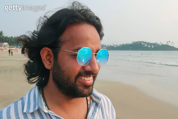 Close-up image of Indian man wearing tinted, mirrored sunglasses on ...