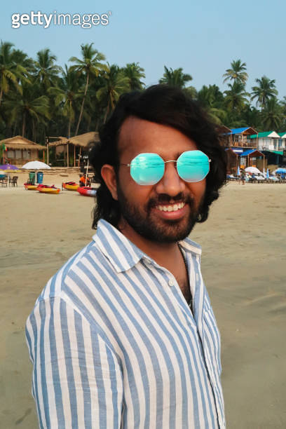 Close-up image of Indian man wearing tinted, mirrored sunglasses on ...