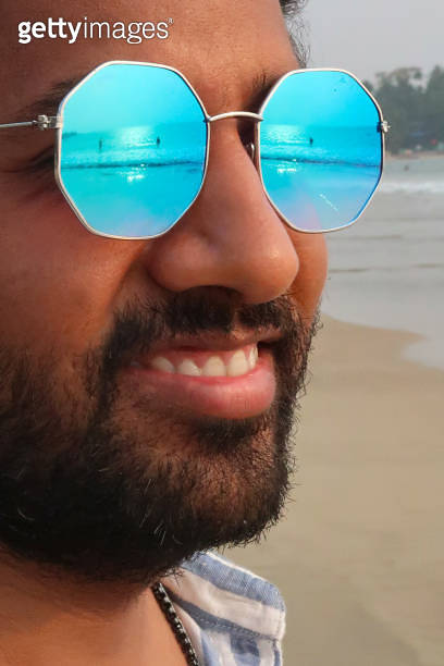 Full frame image of Indian man wearing tinted, mirrored sunglasses on ...