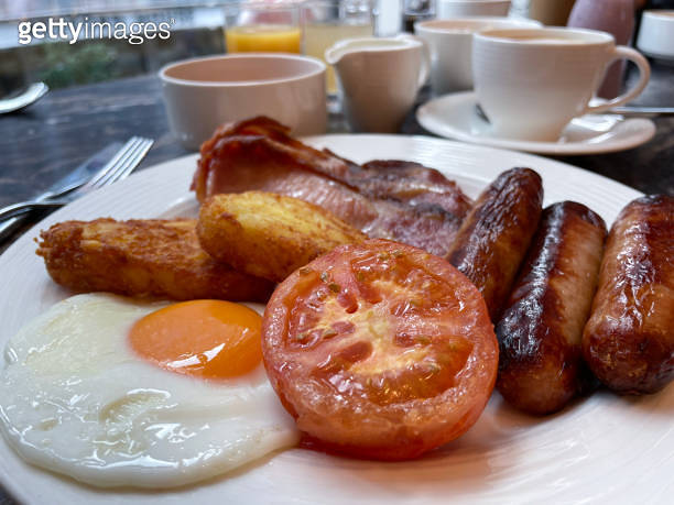 Close-up image of Full English fried breakfast ingredients, sunny-side ...