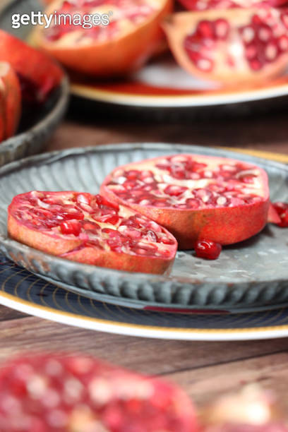 Full frame image of grey plate of pomegranates (Punica granatum ...