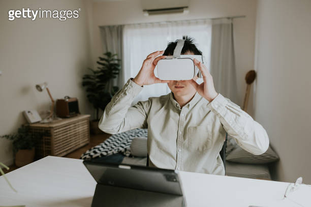 Office worker man setting virtual reality simulator that use for his ...