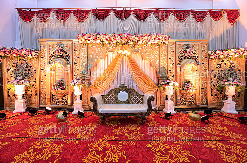 A view of a royal wedding stage setup with a luxury chair for the ...