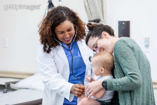 Young single mother holds her baby while the doctor examines her 이미지 ...