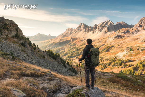 Male hiker hiking with enjoying the French Alps scenic on autumn ...