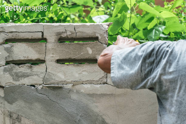 Hand of worker using hammer smashing and demolish on brick wall at ...