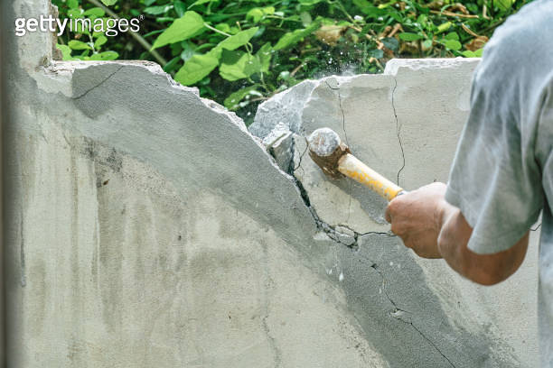 Hand of worker using hammer smashing and demolish on brick wall at ...
