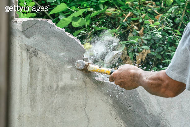 Hand of worker using hammer smashing and demolish on brick wall at ...