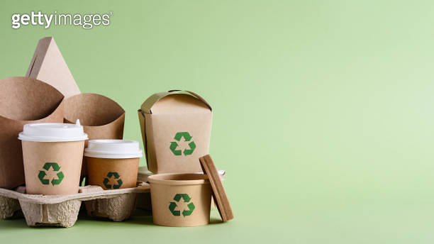 Recycling concept. A set of disposable paper tableware with a recycling ...