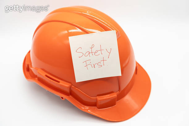 Orange safety hat with message Safety First. hard hat isolated on white ...