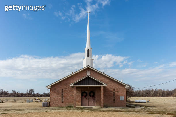 Simple red brick church with local cemetery in deep rural Mississippi ...