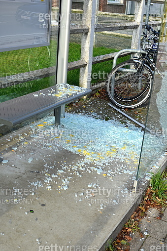 Stationary Dunlop brand bike next to broken glass bus station ...