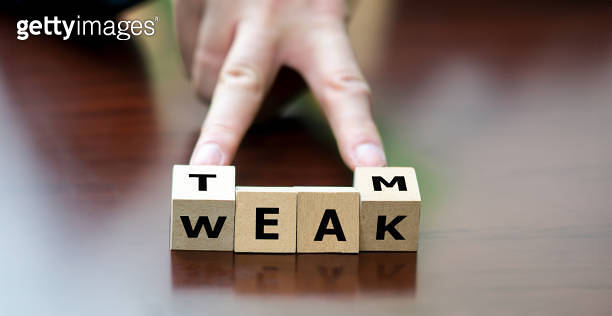 Symbol for being weak without a team. Hand turns wooden cube and ...