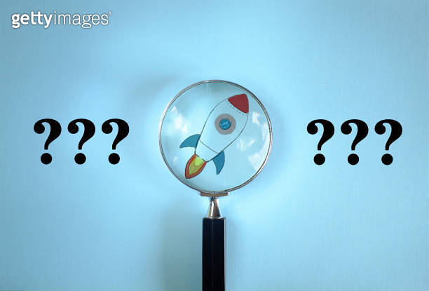 Magnifying glass enlarging the launching rocket ship, symbol for ...