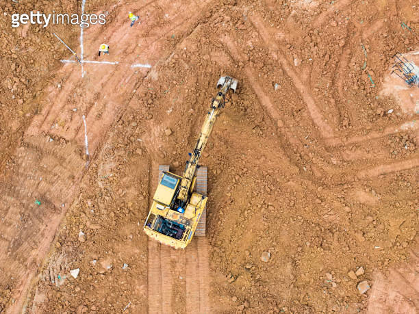 excavator on caterpillars in the foundation pit during the construction ...