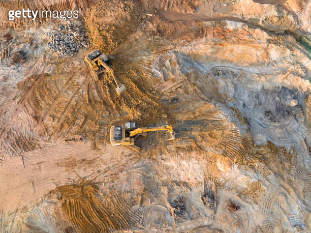 excavator on caterpillars in the foundation pit during the construction ...