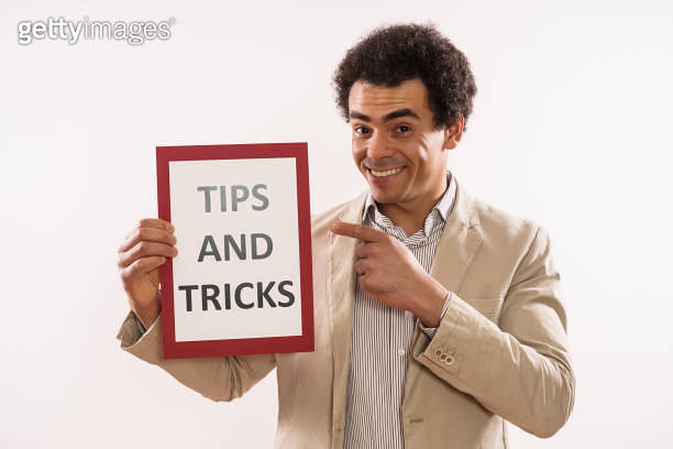 Businessman holding paper with text tips and tricks 이미지 (1463840006 ...