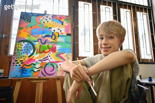 Portrait image of a Young Asian gay Artist boy with colored hair posing ...