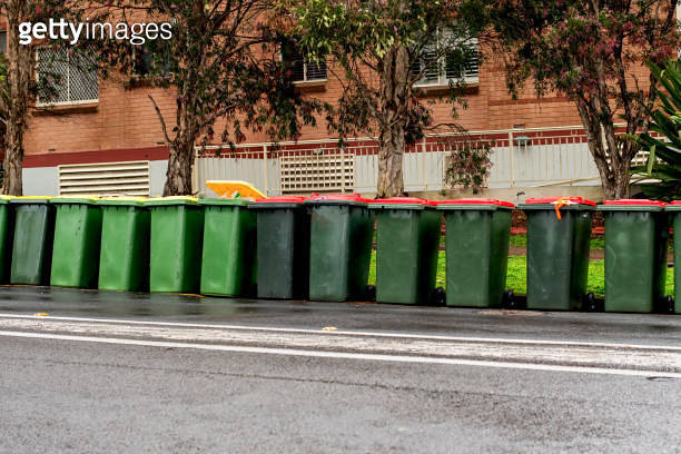 Australian garbage wheelie bins with yellow and red lids for recycling ...