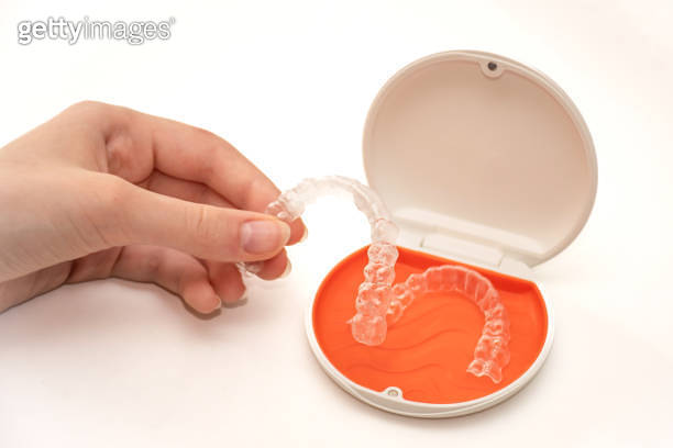 Transparent aligners retainers in a storage case. Invisible braces ...