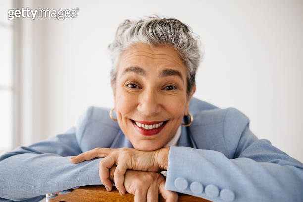 Excited to do it all over again: Mature business woman smiling in her ...