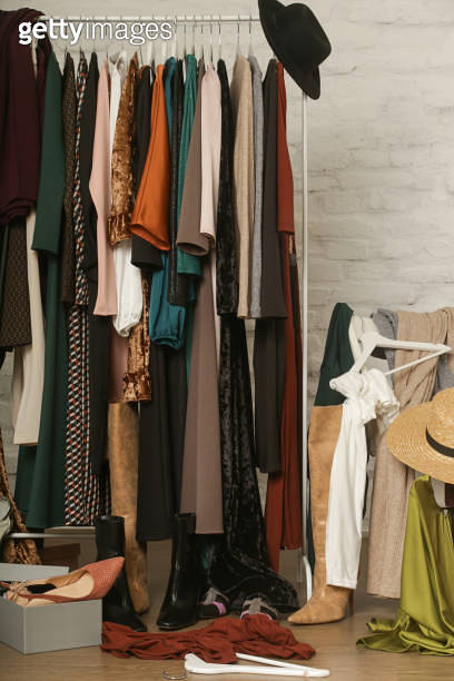 Untidy cluttered woman wardrobe with stylish clothes and accessories ...