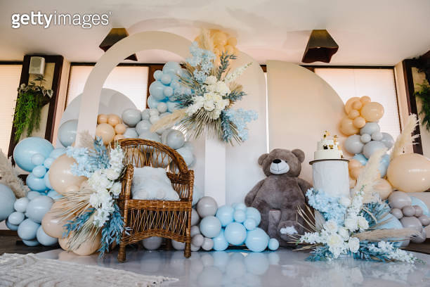 Arch with bear, wicker wooden chair. Photo wall decoration blue, brown, grey balloons, autumn ...