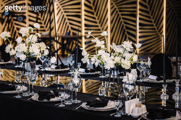 Banquet decoration composition flowers, candles, candlesticks in hall ...