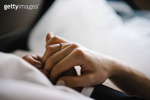 The bride and groom hold hands on the wedding ceremony. Hands with ...
