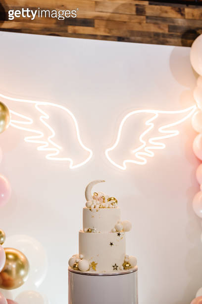 Trendy cake with decor. Celebration baptism concept. Arch decorated with pink, white, golden ...