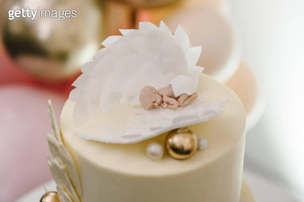Details trendy cake with figure angel. Celebration baptism concept. Reception at birthday party ...