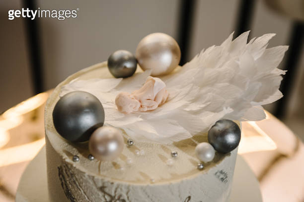 Cake on background luxury photo zone. Trendy baptism cake with figure newborn, wings angel and ...