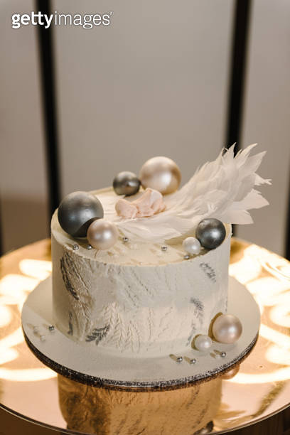 Cake on background luxury photo zone. Trendy baptism cake with figure newborn, wings angel and ...
