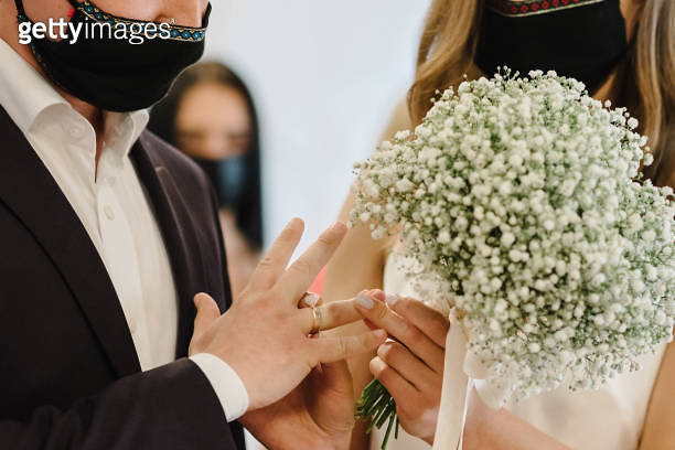 Young bride and groom in medical masks during quarantine on their ...