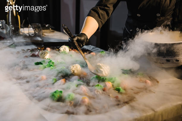 Pastry chef holding a bowl preparing delicious chocolate at kitchen ...