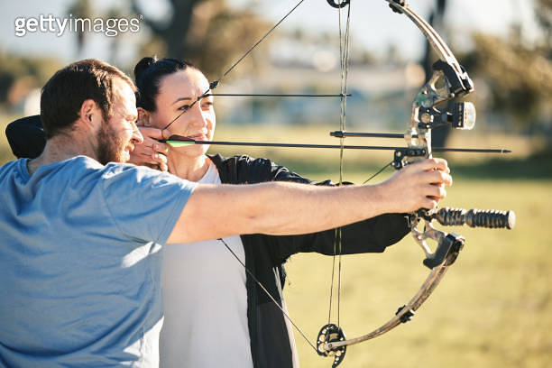 Archery, aim and shooting range sports training with a woman and man ...