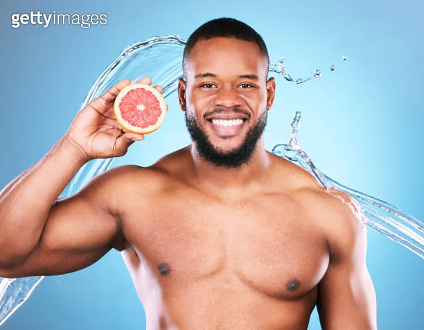 Portrait, happy or black man with grapefruit for facial skincare cleaning, vitamin c or cosmetic ...