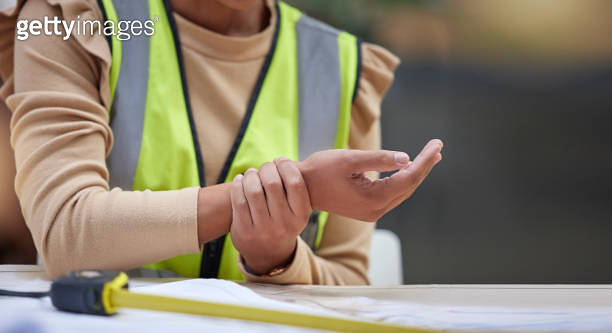 Industry, closeup and female construction worker with wrist pain ...