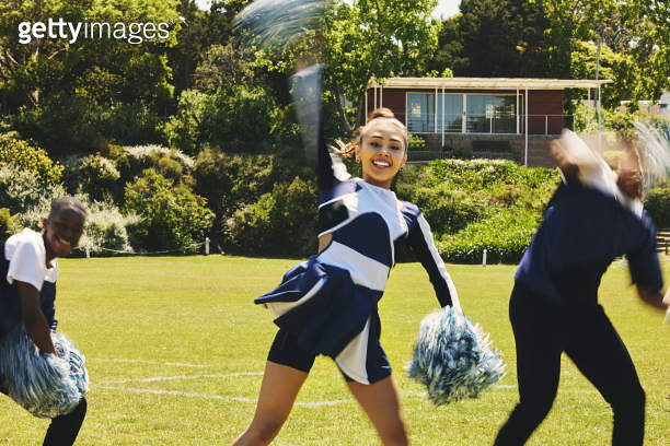 Cheerleader, people and teamwork with hand up in routine at university ...
