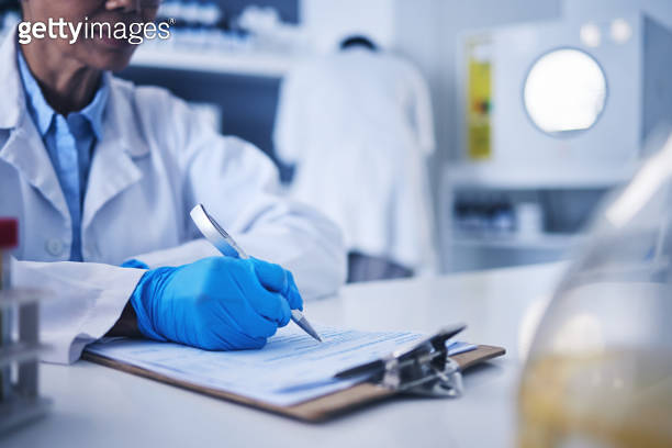 Woman scientist, documents and hands writing vaccine review, planning ...