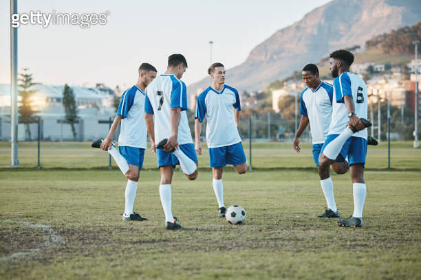 Soccer, team sports and stretching exercise on field for fitness ...