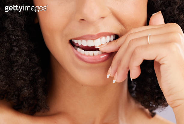 Woman, mouth and teeth closeup, flirt and bite finger with hand and ...