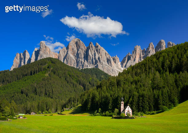 St Johann Church with landscape view of dolomites mountain peaks and ...
