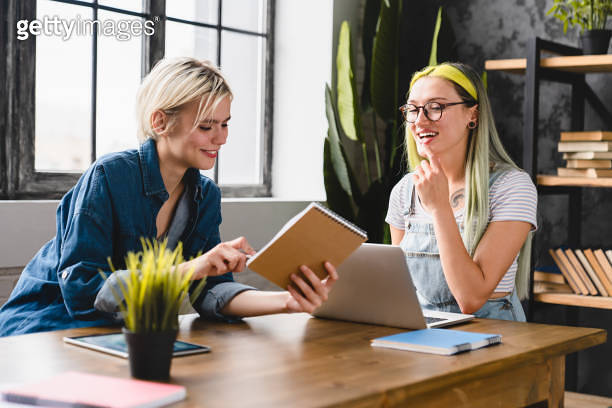 Loving young caucasian female lgbtq couple lesbians reading books ...