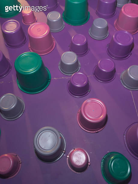 Colorful plastic pail bucket hanging on the eall for installation with ...