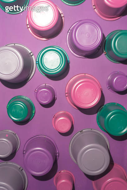 Colorful plastic pail bucket hanging on the eall for installation with ...