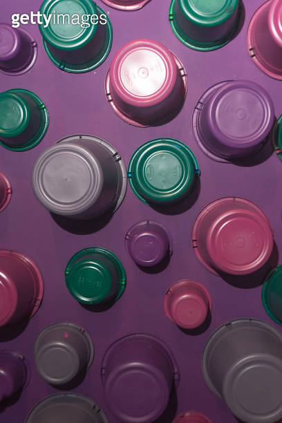 Colorful plastic pail bucket hanging on the eall for installation with ...