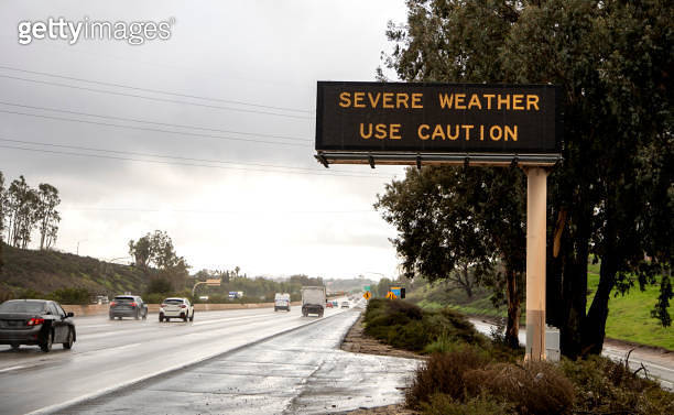 Digital sign at freeway stating Severe Weather Use Caution with wet ...