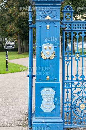 , blue and gold ornate gates and posts outside and the entrance to ...