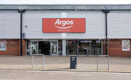 Argos store entrance. Big red and white sign over glass doors. Argos is ...